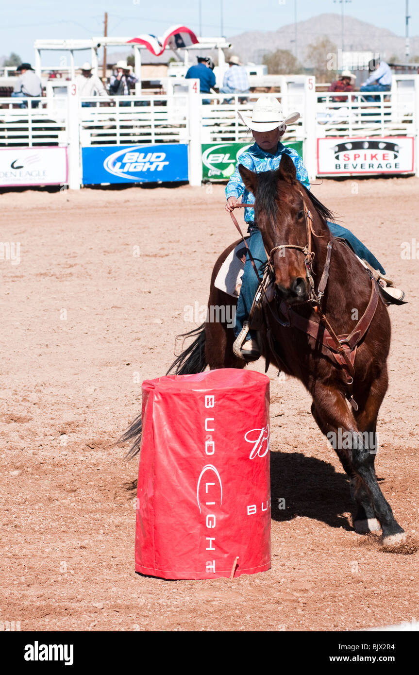 a cowgirl competes in the barrel racing event at a rodeo Stock Photo ...