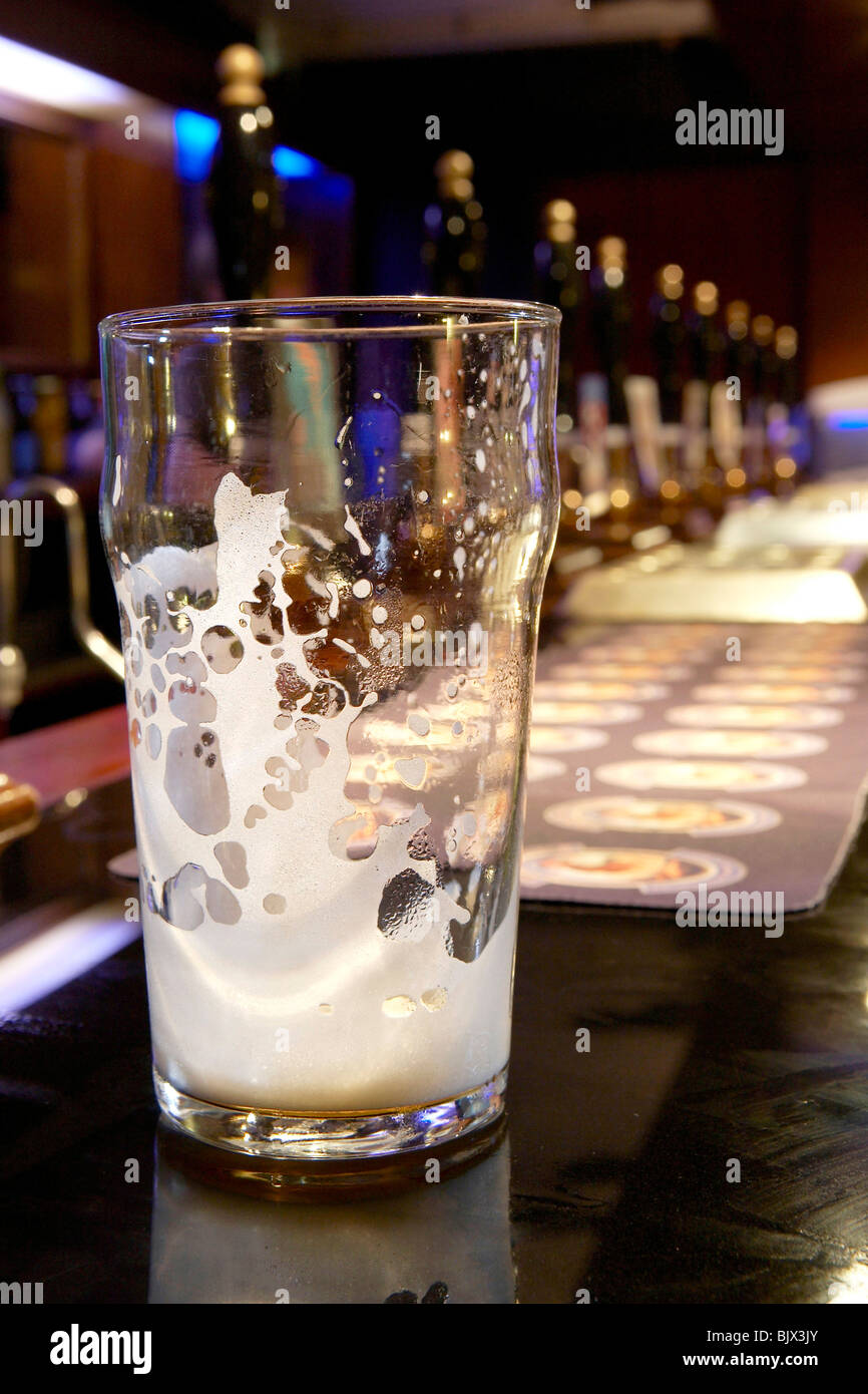 Empty pint glass on a bar Stock Photo - Alamy