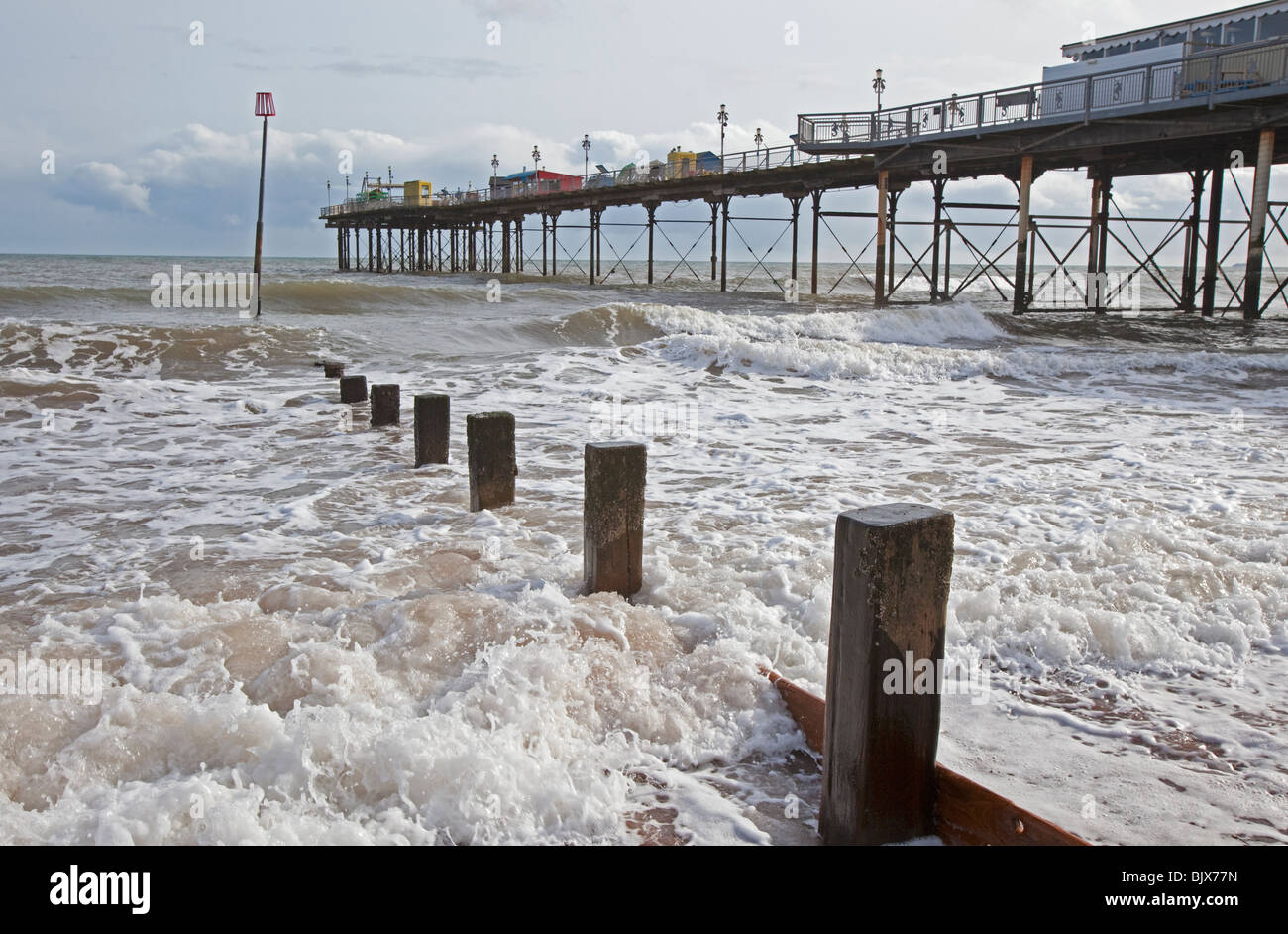 Groynes with pier in the sea, Teignmouth Beach, Devon, England Stock ...