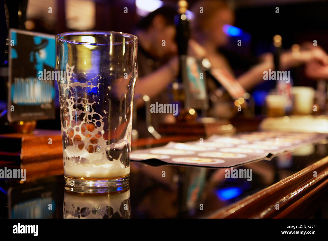 Empty pint glass on a bar Stock Photo - Alamy