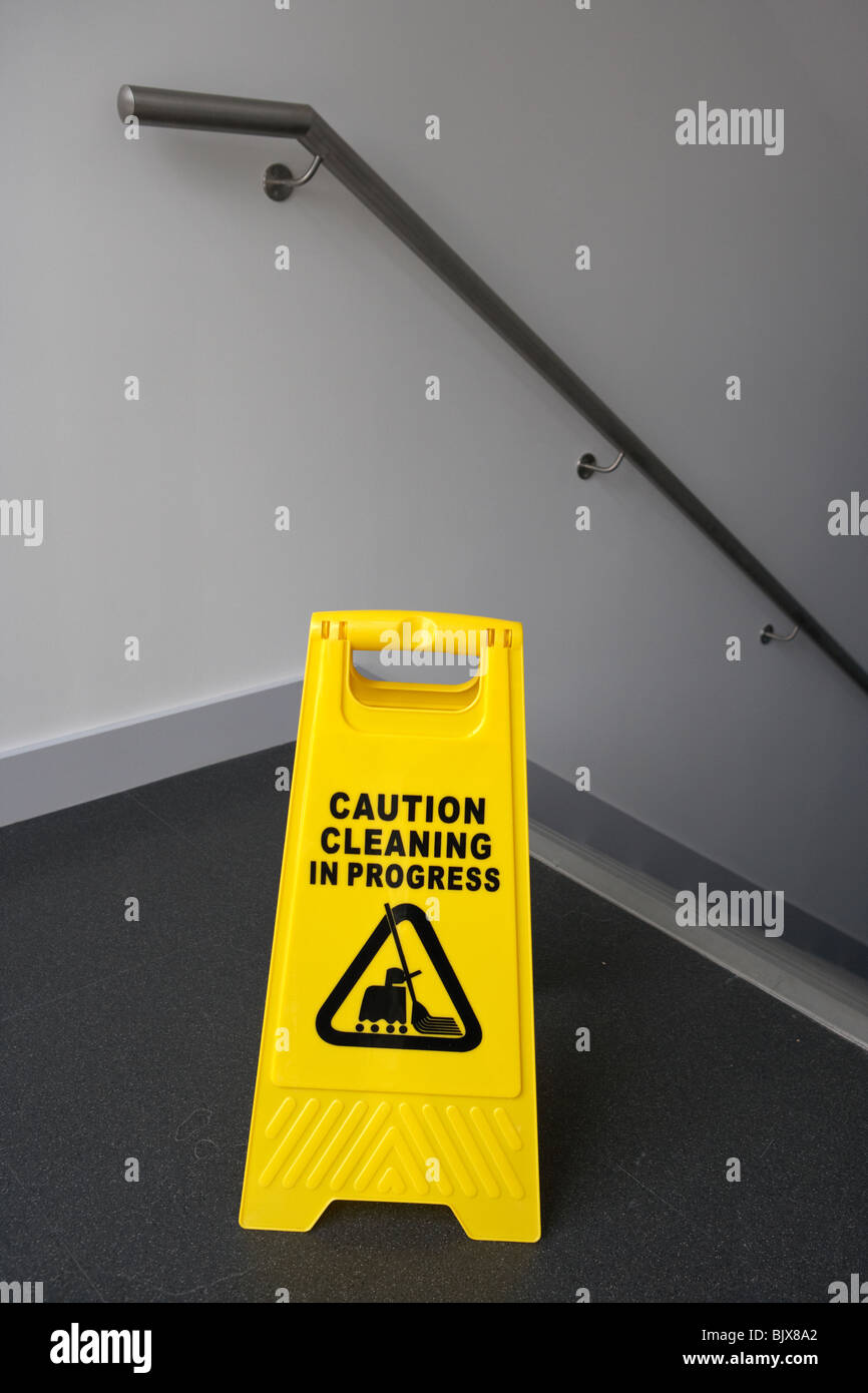 caution cleaning in progress sign at the top of a set of stairs in a ...