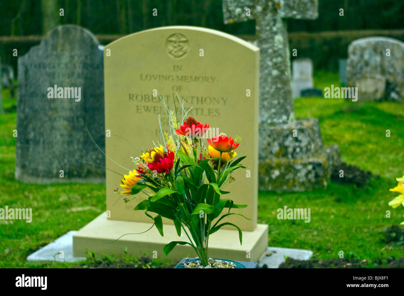 A Posy Of Flowers In Front Of A Blurred Gravestone Stock Photo - Alamy