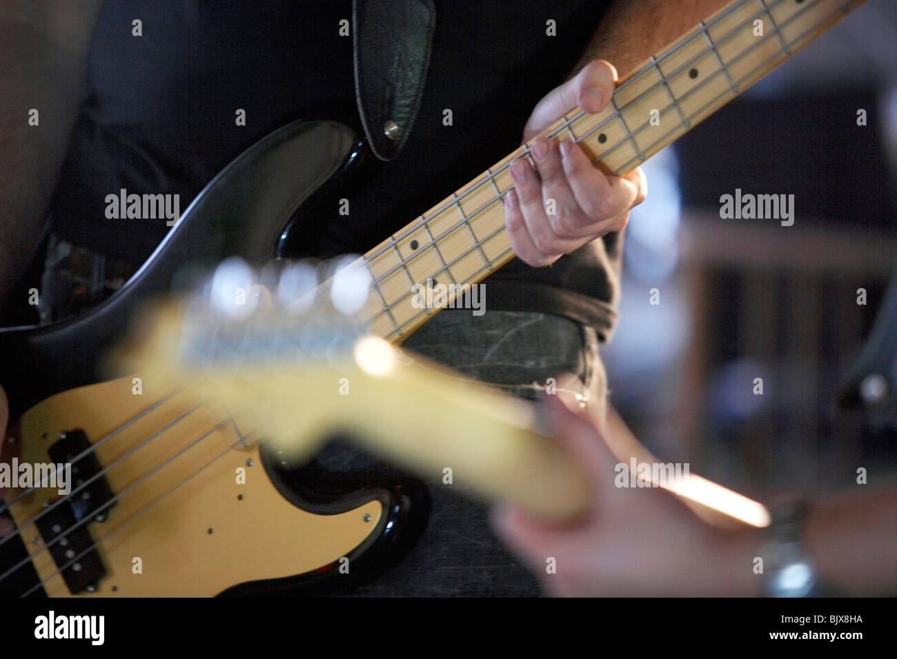 Bass guitarist playing instrument Stock Photo - Alamy