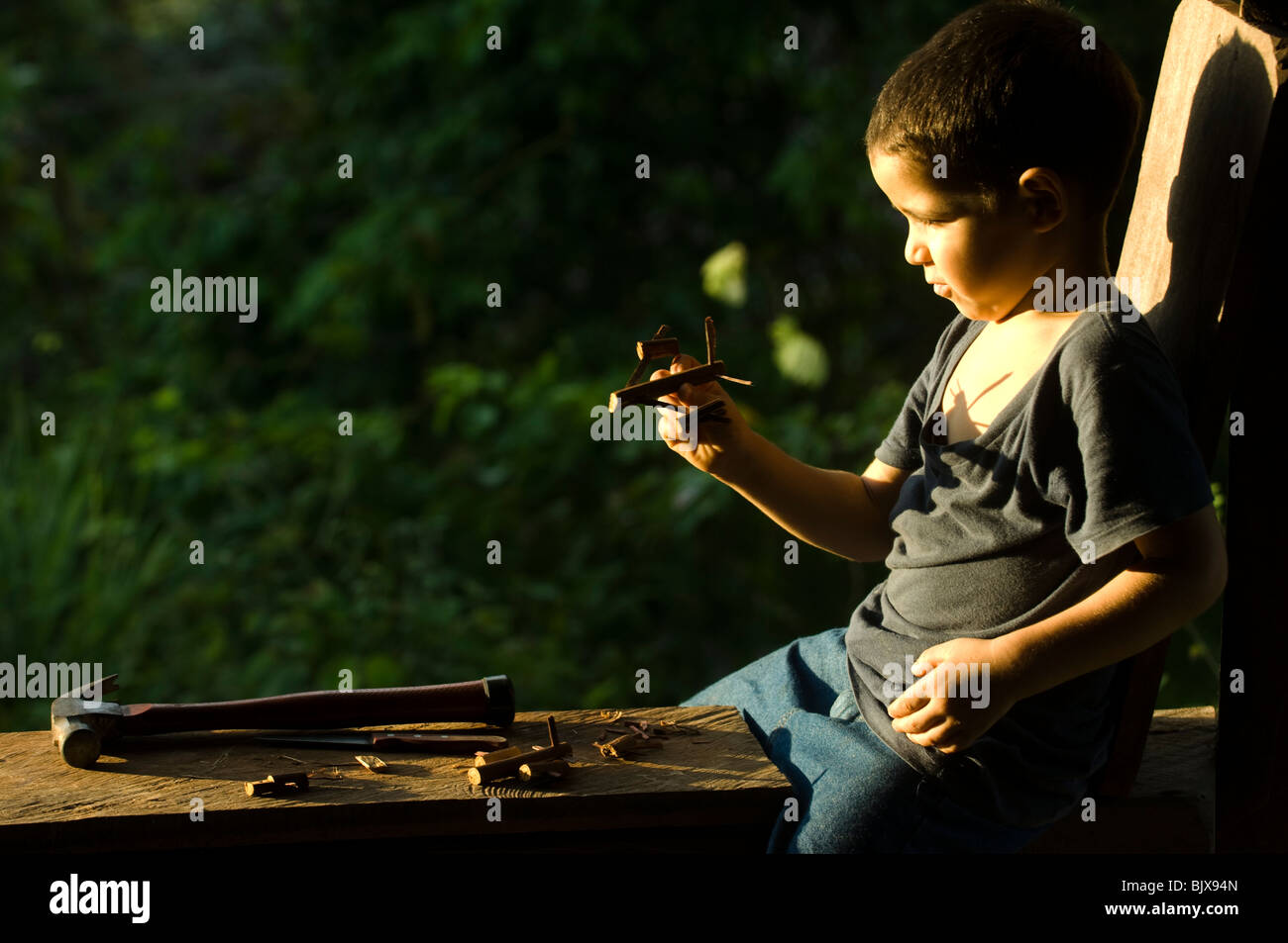 Child building a simple organic toy made from leaves Stock Photo - Alamy
