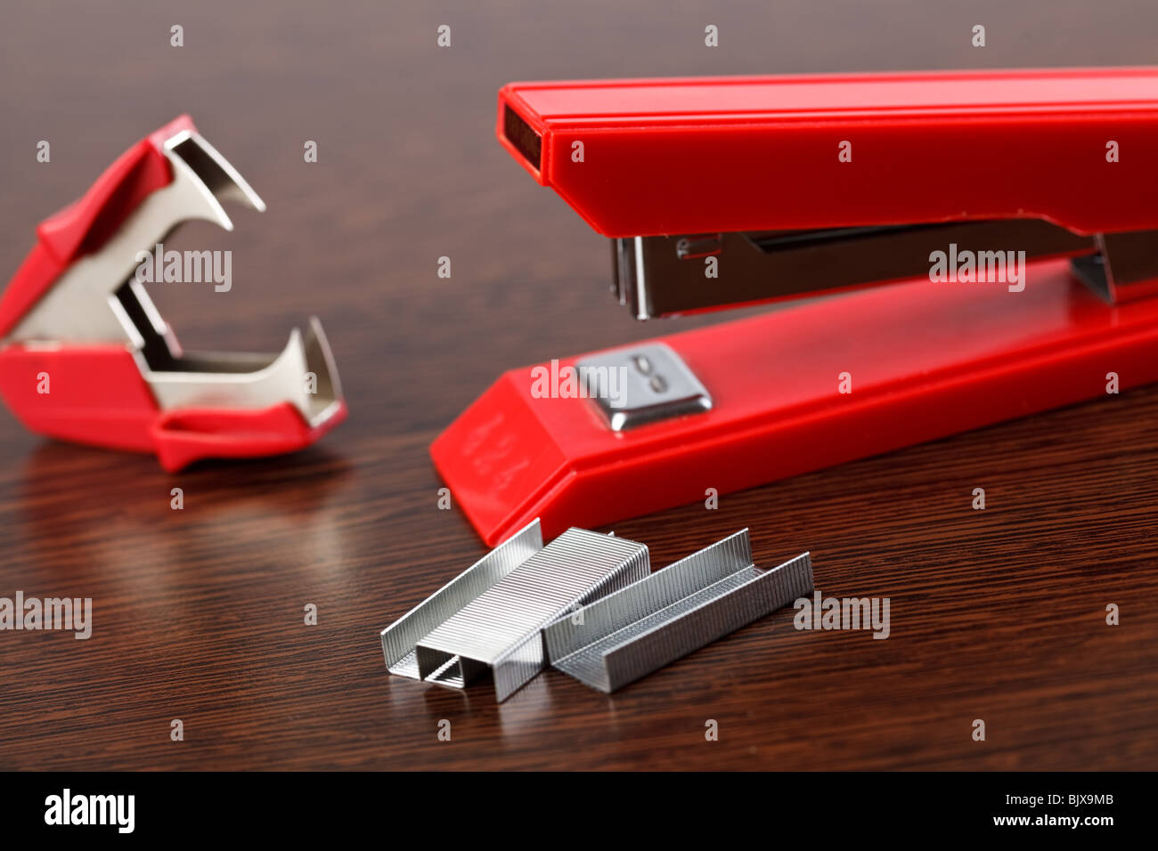 office stapler on wooden table Stock Photo - Alamy