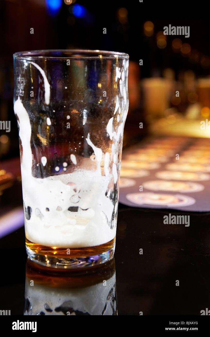 Pint glass on a bar Stock Photo - Alamy