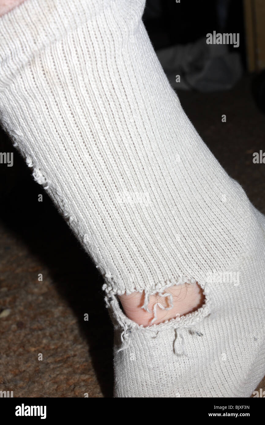 Hole in heel of white crew sock Stock Photo - Alamy