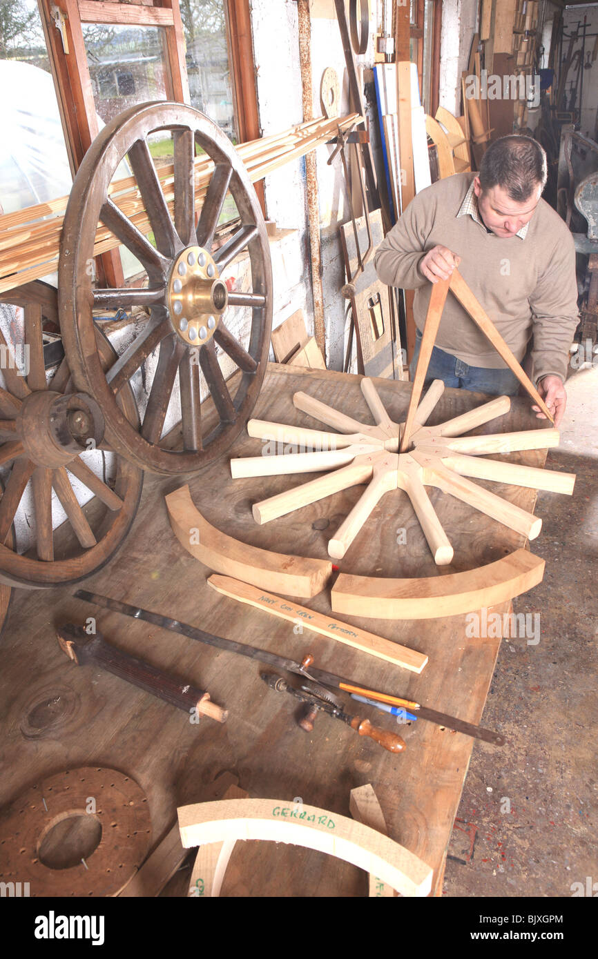 Traditional wheelwright Greg Rowlands working on a new wheel using ...