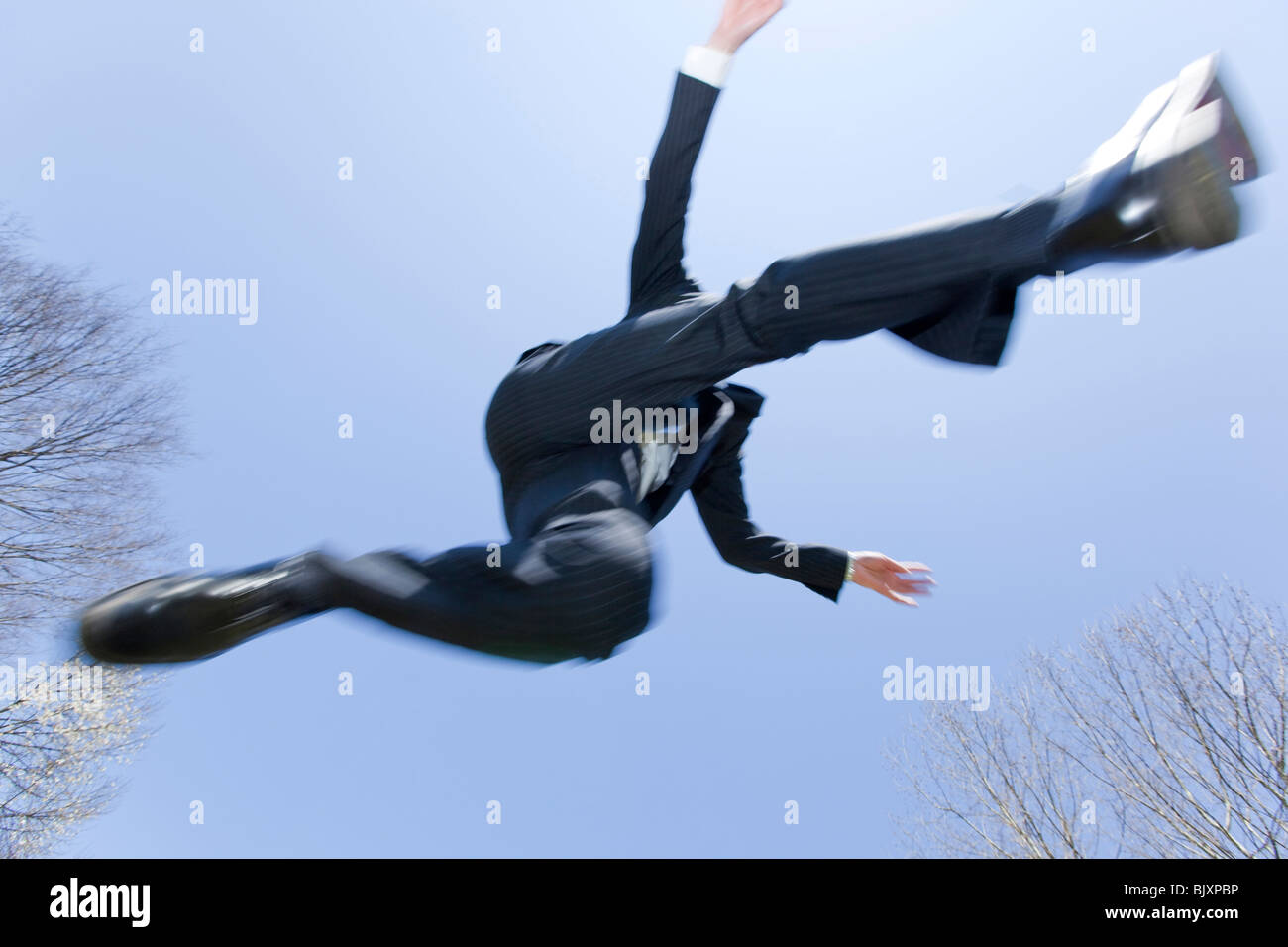 Young businessman jumping Stock Photo - Alamy