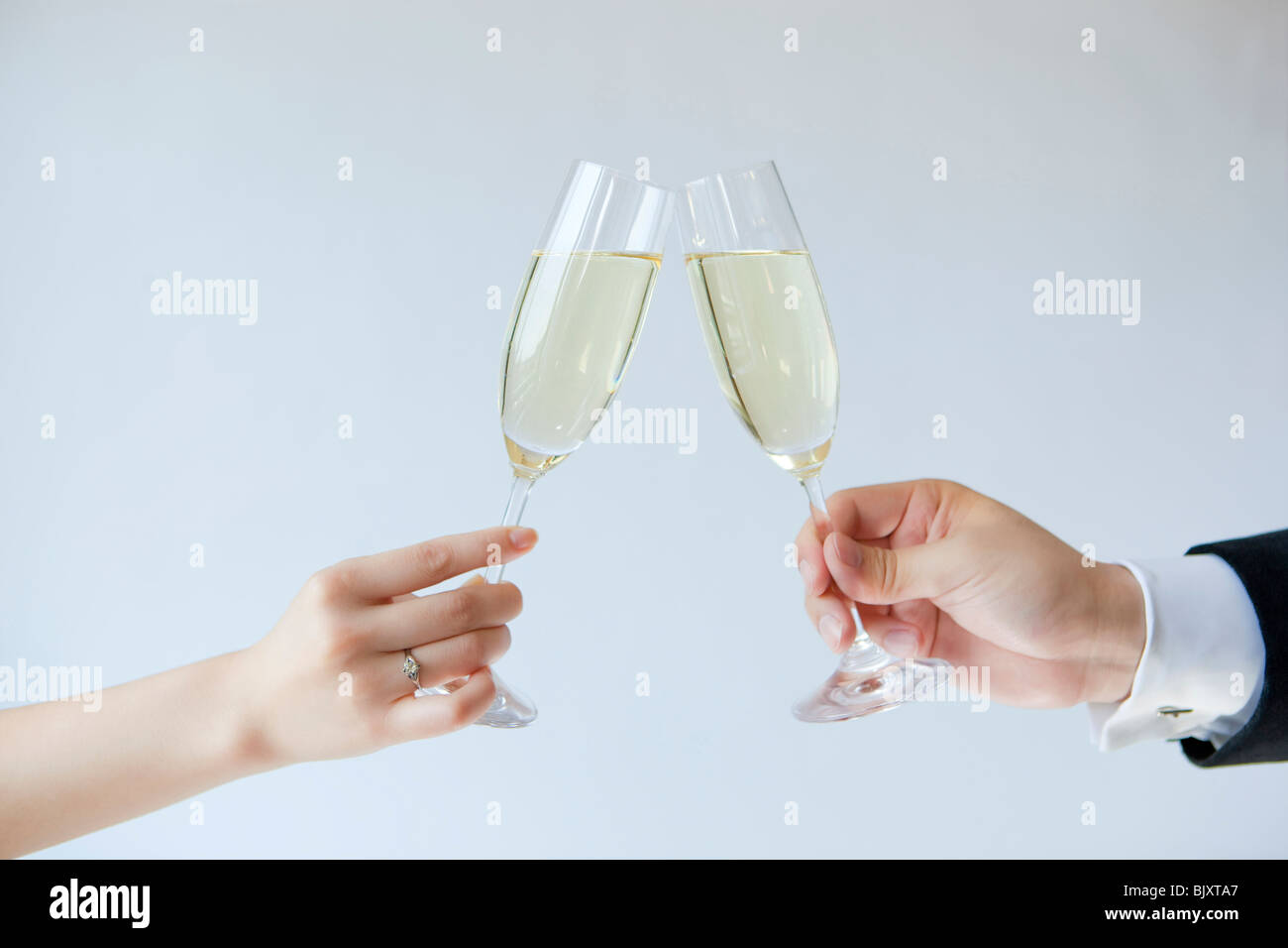 Hands of couple toasting with champagne Stock Photo - Alamy