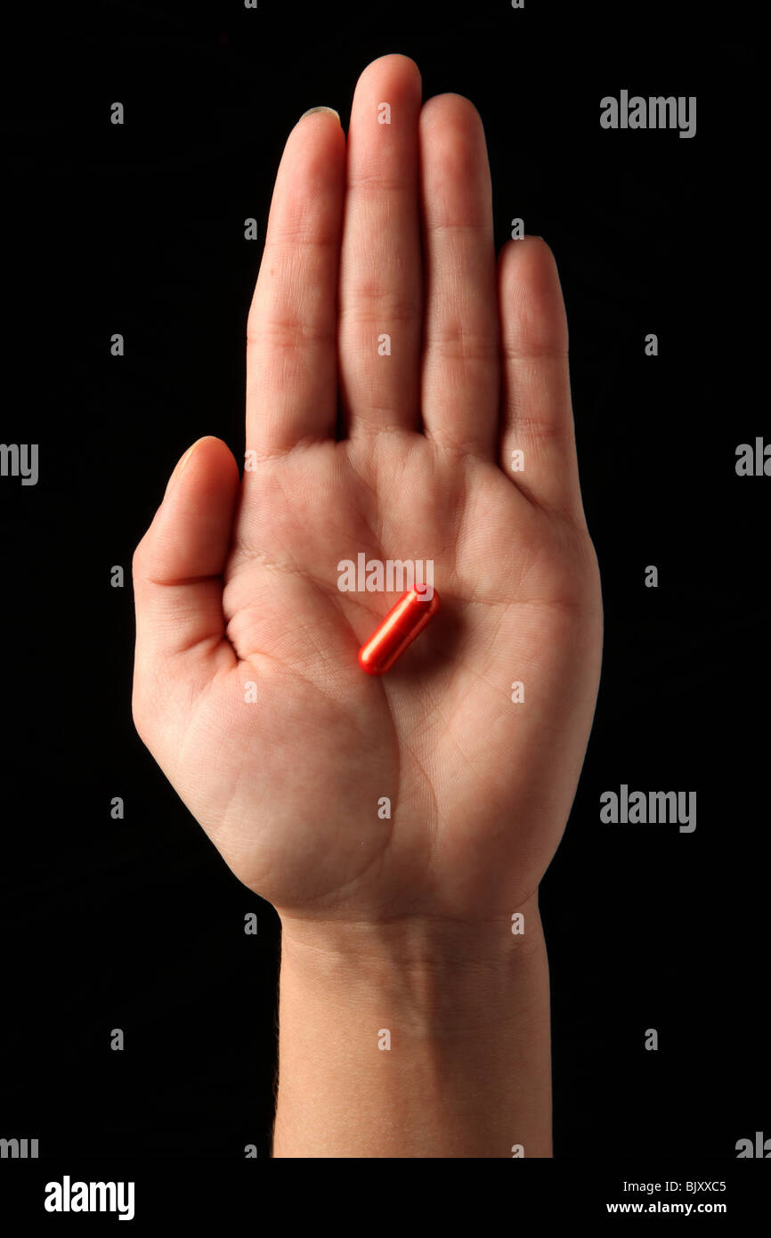 A female woman's hand holding one pill in the palm of her hand Stock ...