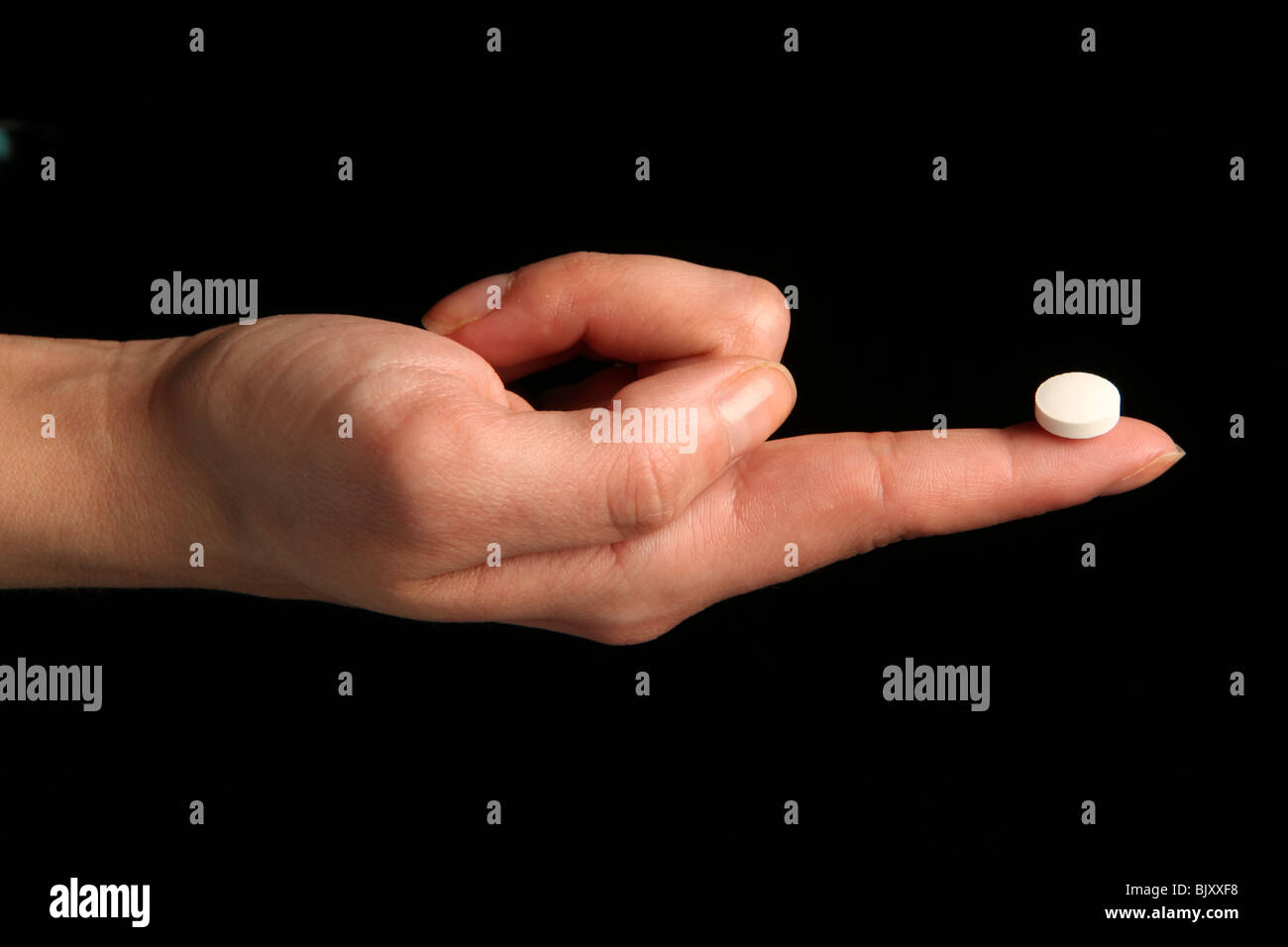 Hand holding pill between finger hi-res stock photography and images ...
