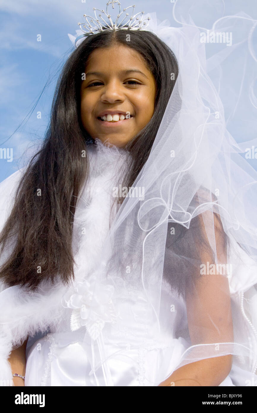 Young Hispanic princess age 11 in white gown wearing a crown. Cinco de ...