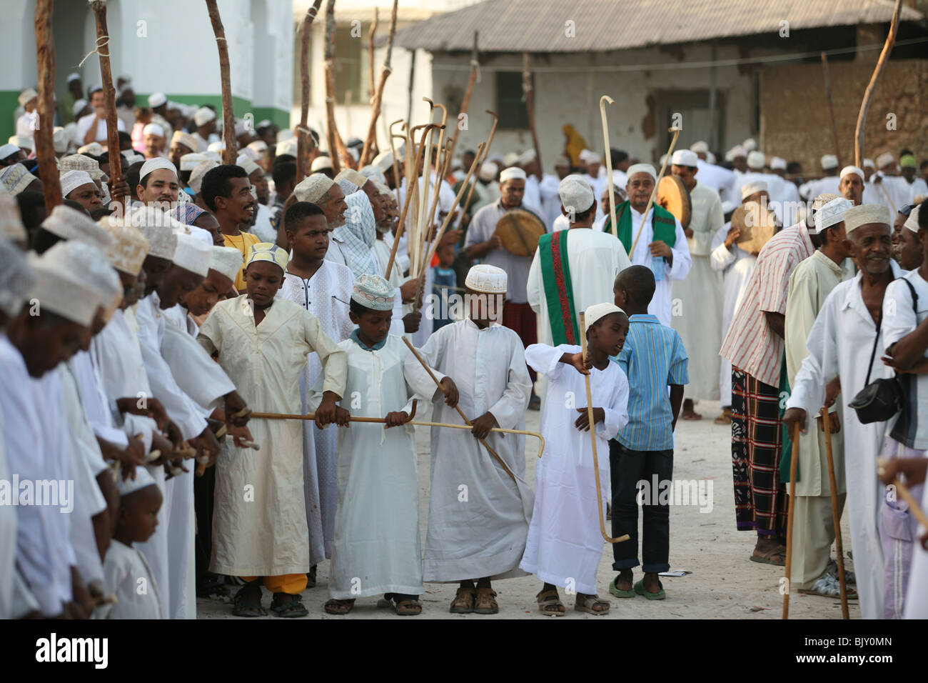 Men and boys celebrate Maulidi with the stick dance, Kirumbizi outside ...