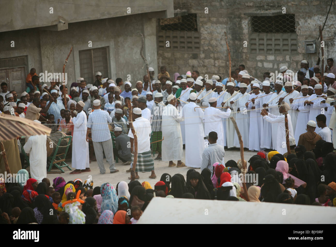 Men perform the Stick dance Kirumbizi during maulidi outside Riyadha ...