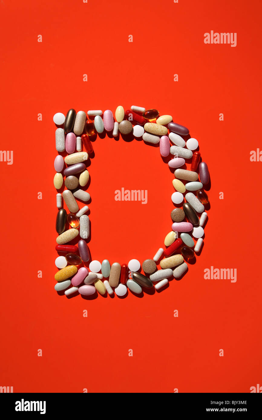 The shaped of the letter B formed with many colorful pills, tablets and ...