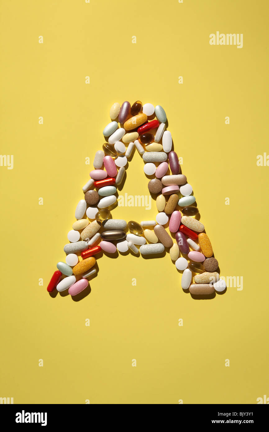 The shaped of the letter B formed with many colorful pills, tablets and ...