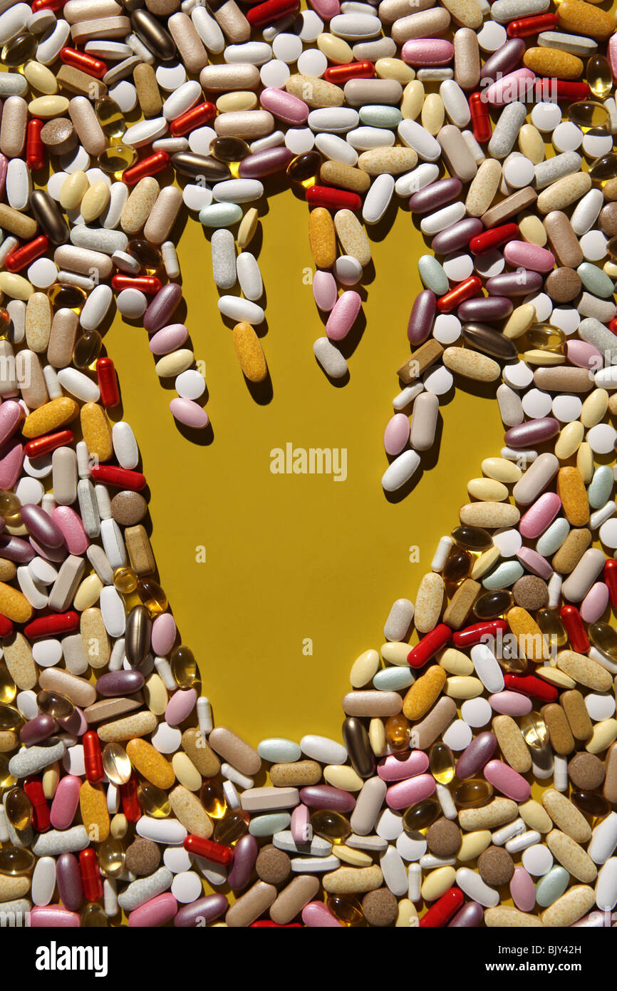 An blank space for a hand print with a background of colorful capsules ...