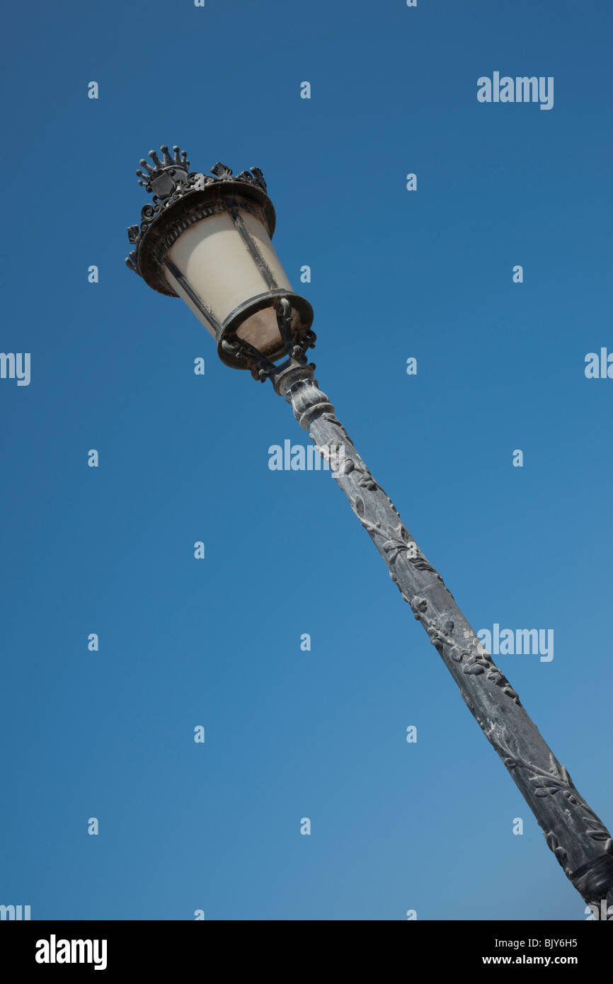 Old historic iron lamp post against clear blue sky Stock Photo - Alamy