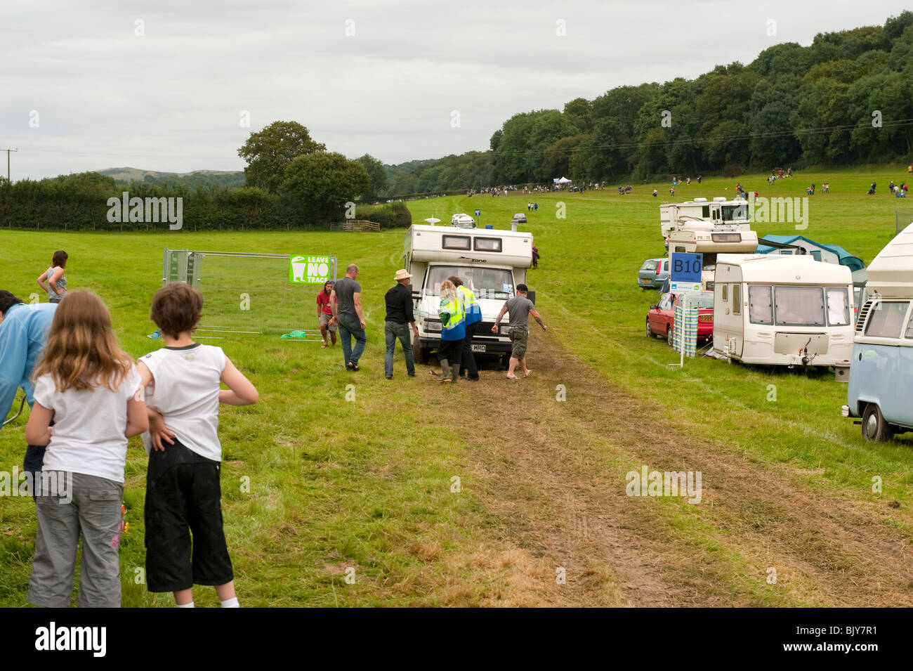 Motorhome bogged down in mud at rock festival camp site Stock Photo - Alamy