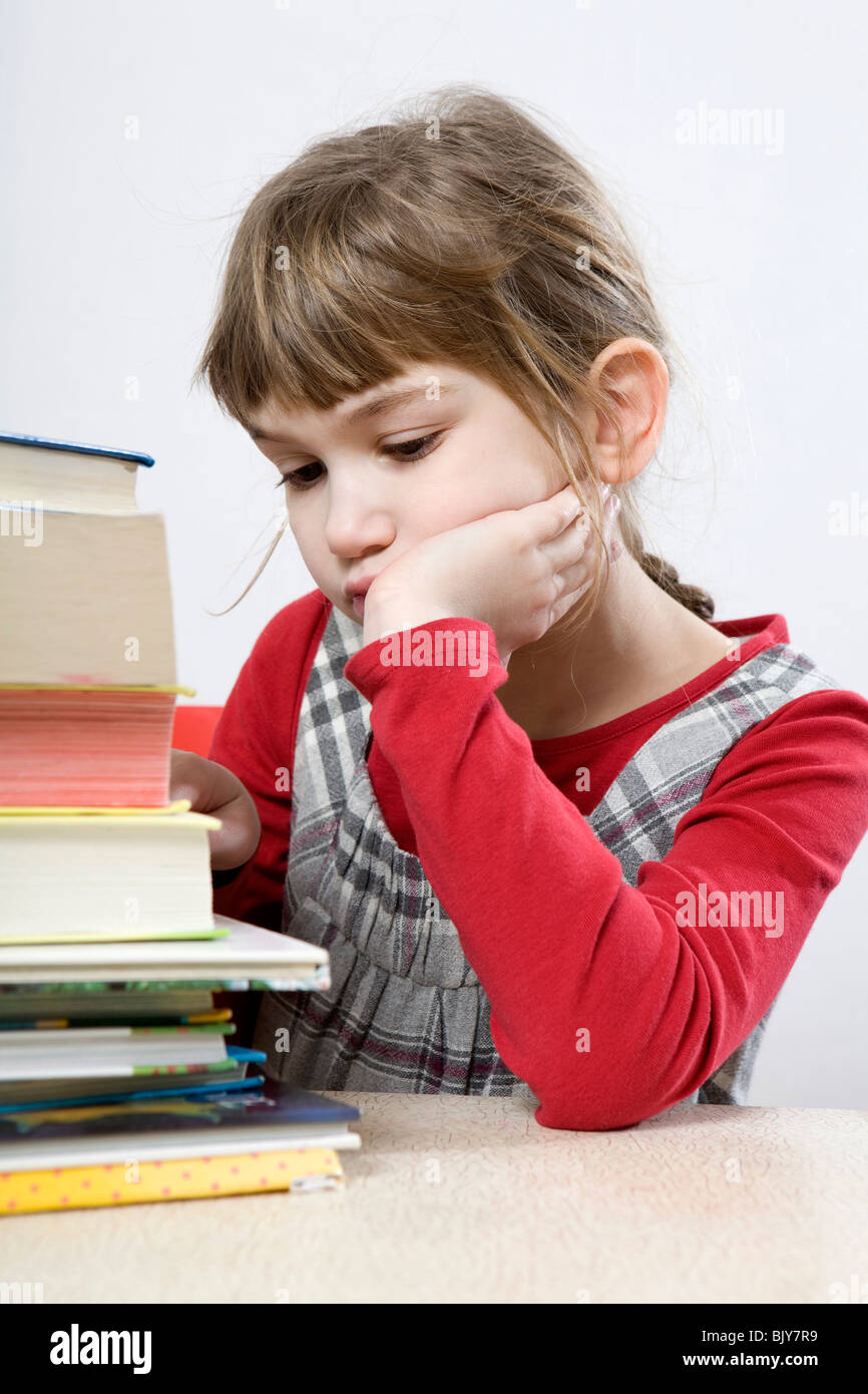 Is it possible to read all these books? little cute sad girl with a ...