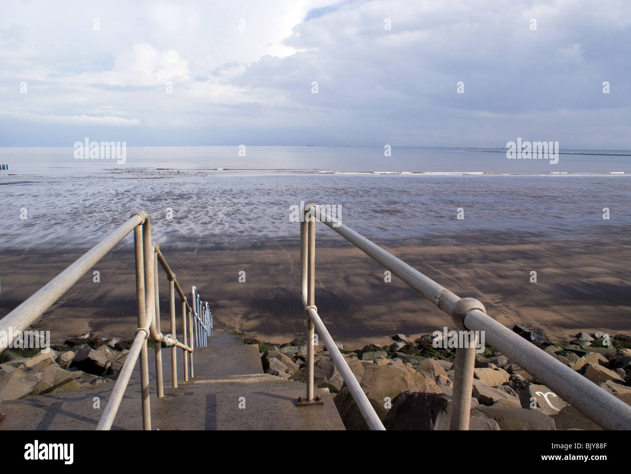 STEPS LEADING DOWN TO THE SEA COAL COVERED BEACH AT SEATON CAREW ...
