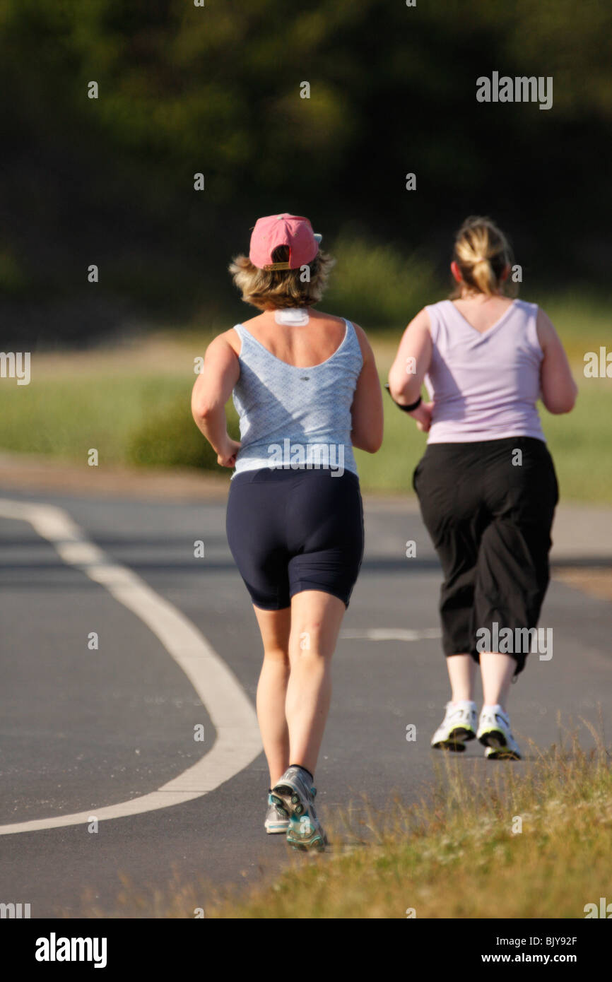 Rear View of Two Women Jogging Stock Photo - Alamy