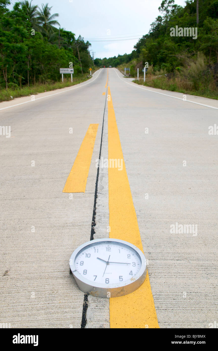 Clock on a road Stock Photo - Alamy