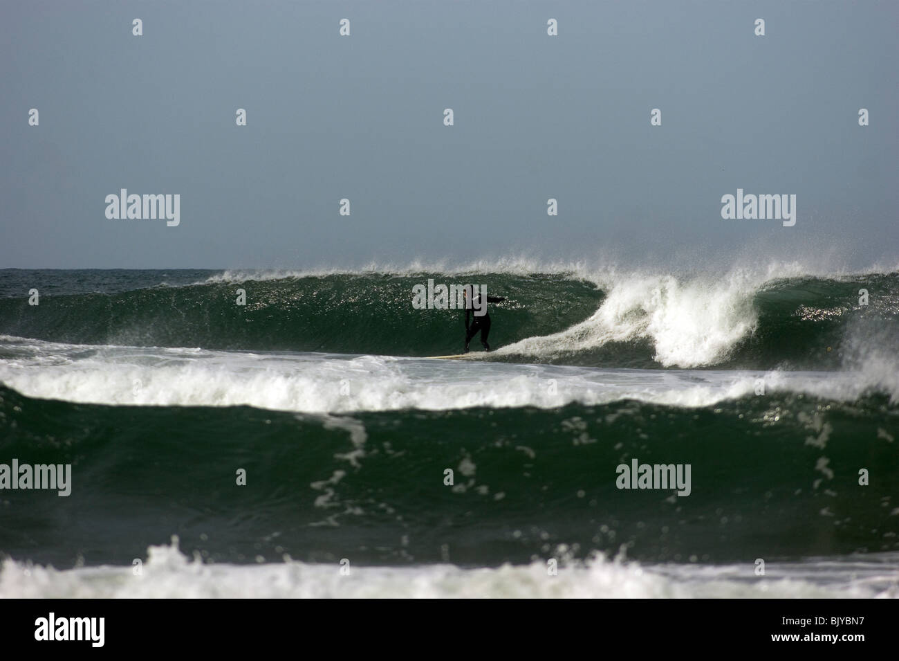Surfer handles waves on the west coast in the Pacific Ocean of Oregon ...