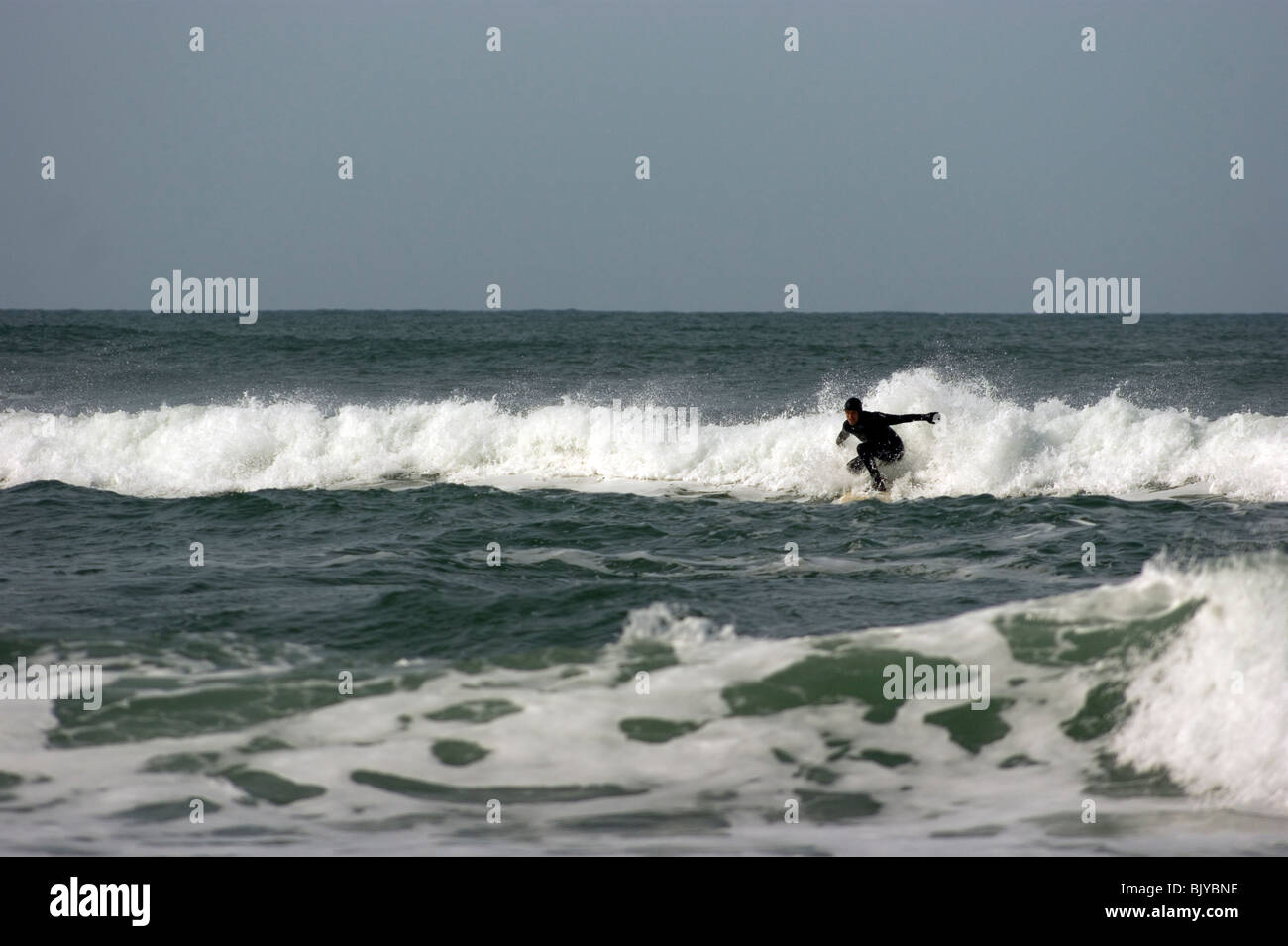 Surfer handles waves on the west coast in the Pacific Ocean of Oregon ...