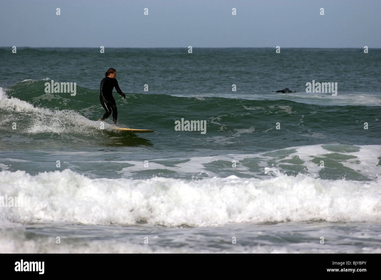 Surfer handles waves on the west coast in the Pacific Ocean of Oregon ...