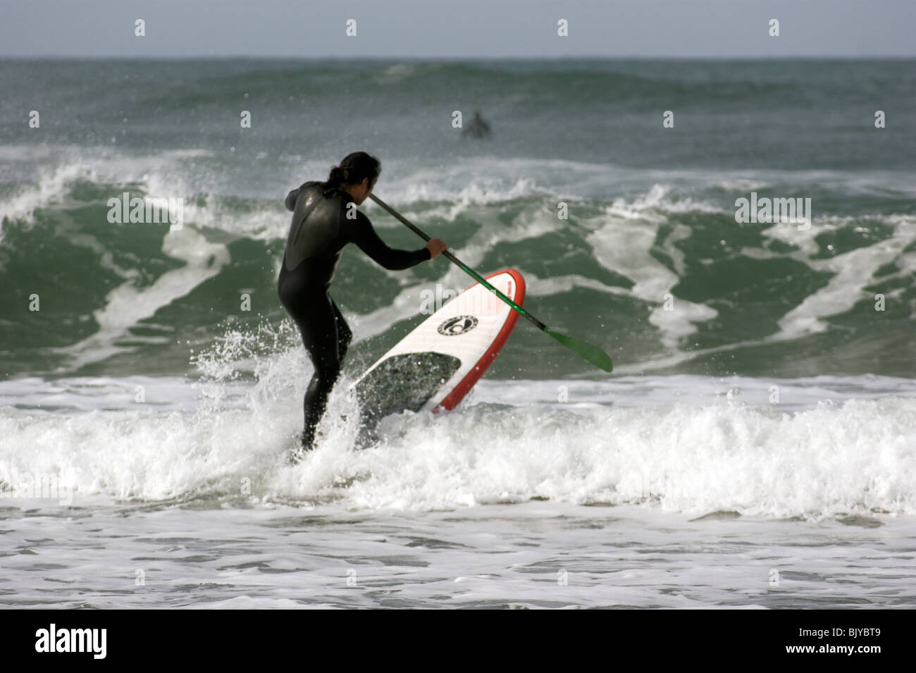 Surfer handles waves on the west coast in the Pacific Ocean of Oregon ...