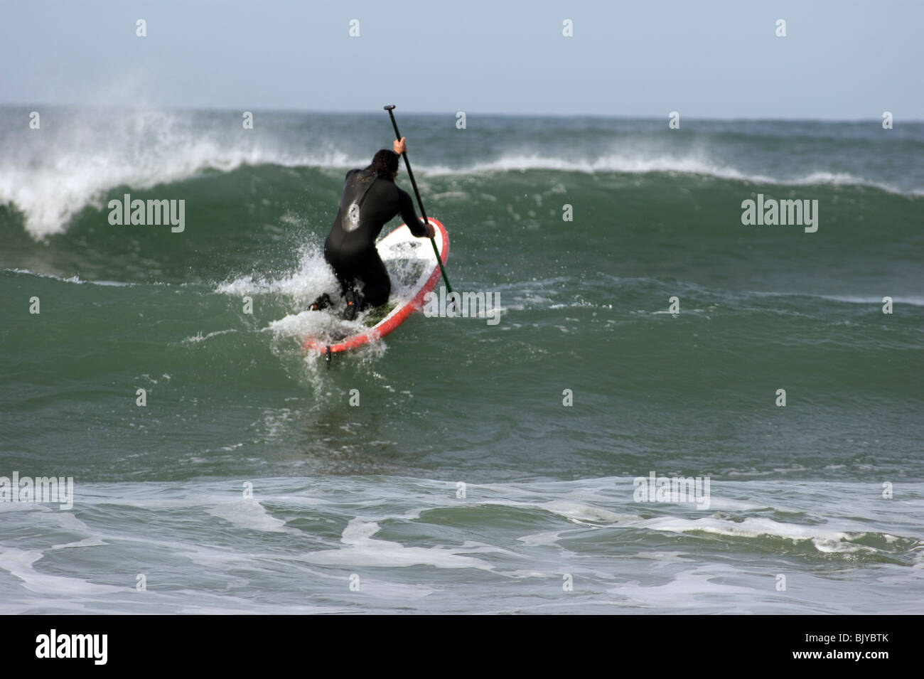 Surfer handles waves on the west coast in the Pacific Ocean of Oregon ...