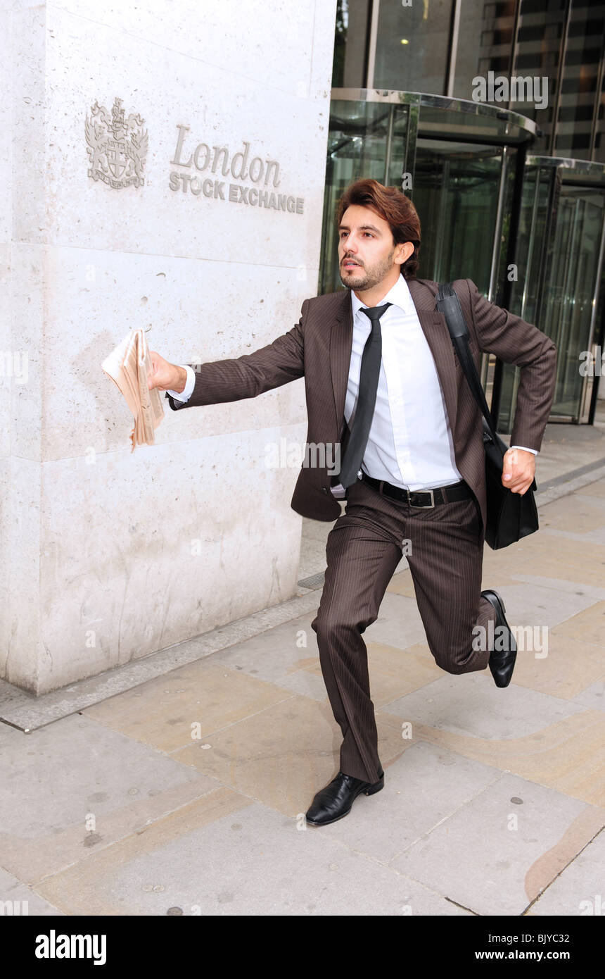 Vertical image of a business man running along outside the London Stock ...