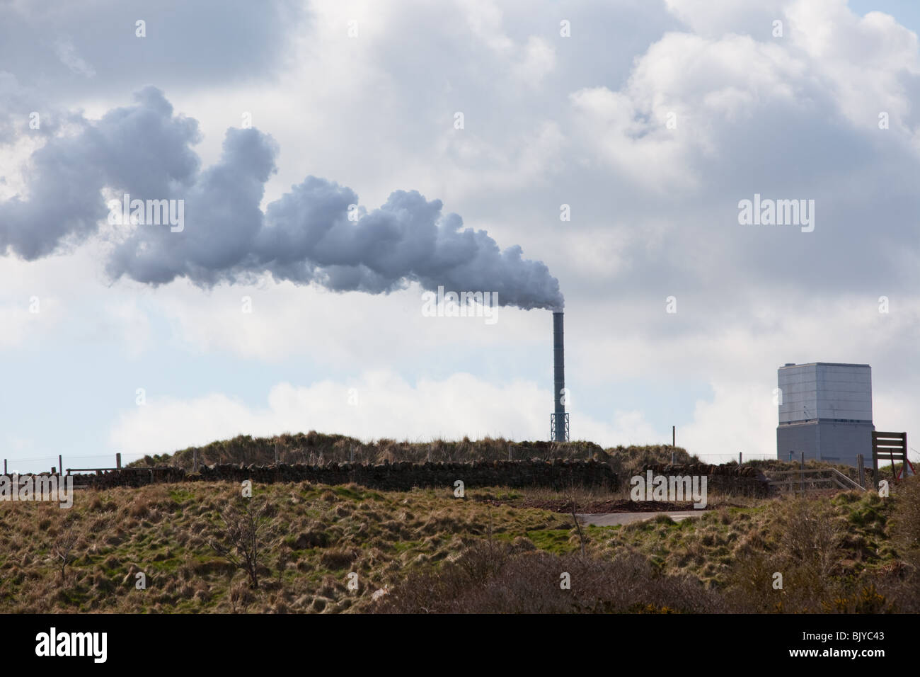 A factory chimney belching out smoke Stock Photo - Alamy