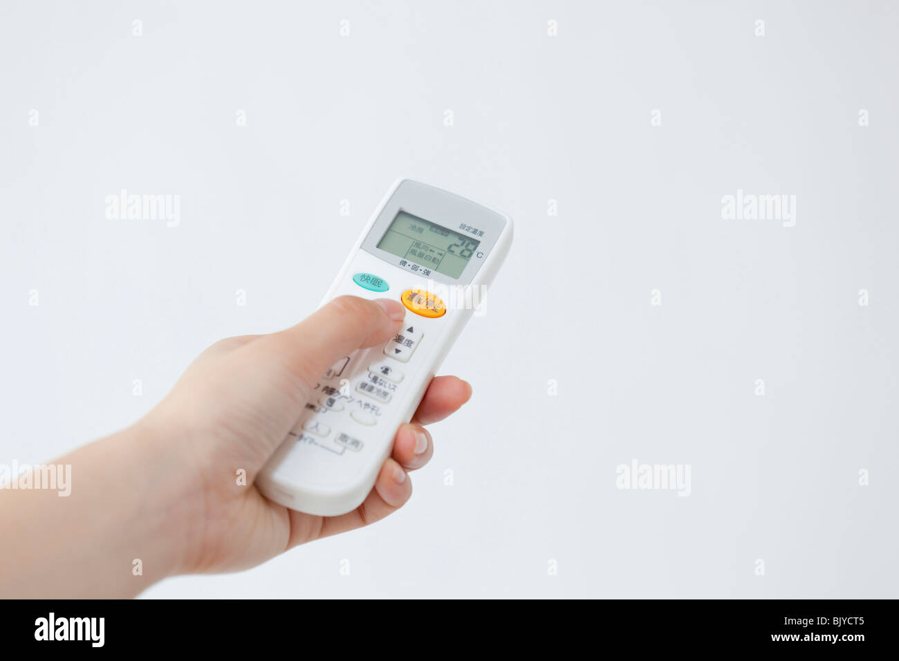 Hand of a woman holding remote controller Stock Photo - Alamy