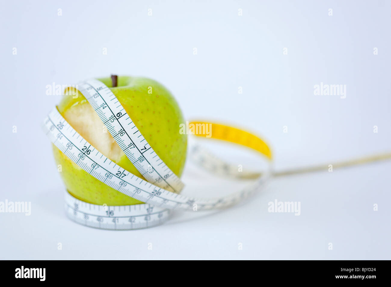 Tape measure and apple Stock Photo - Alamy