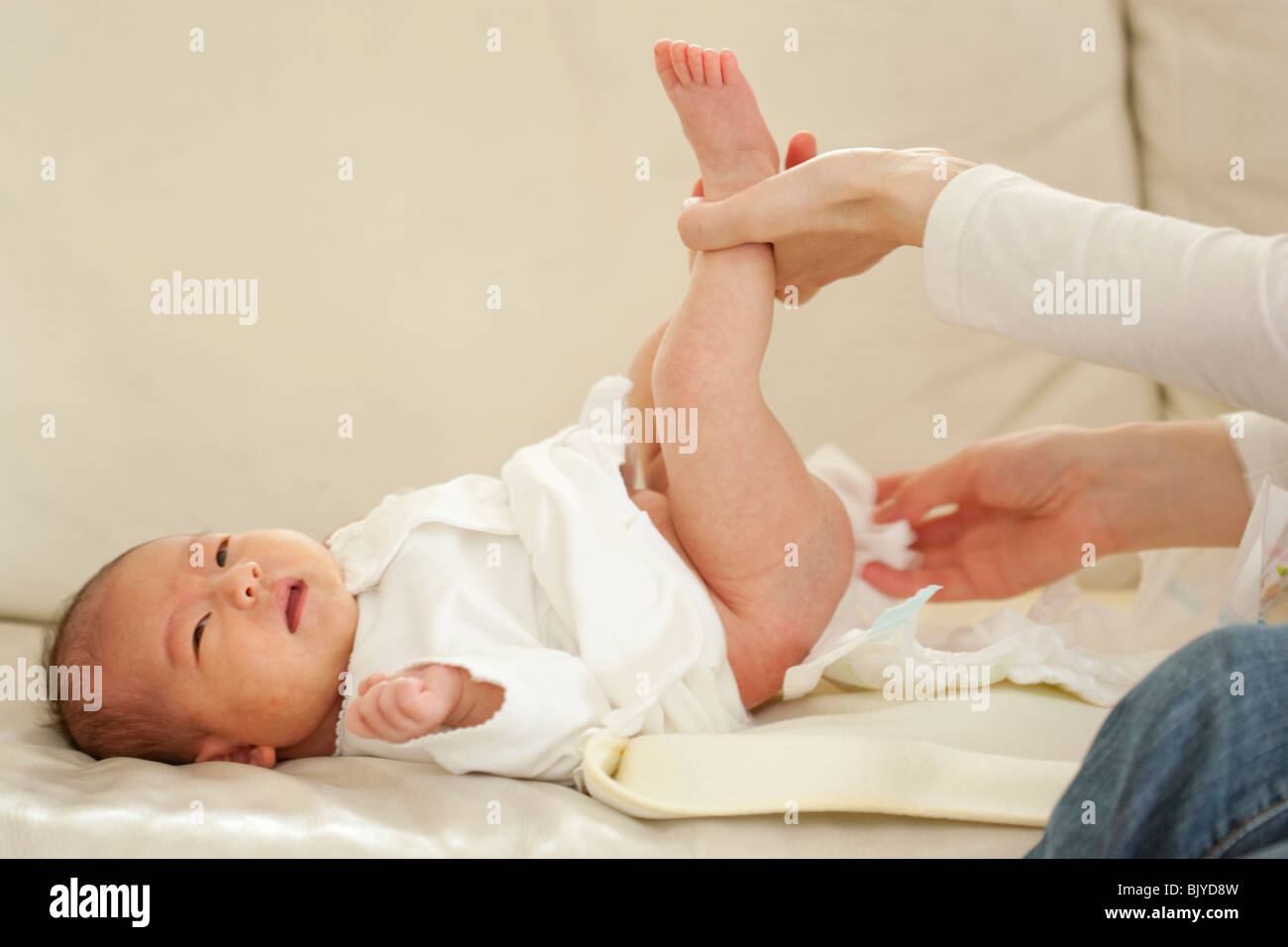 Mother changing diaper of a baby Stock Photo - Alamy