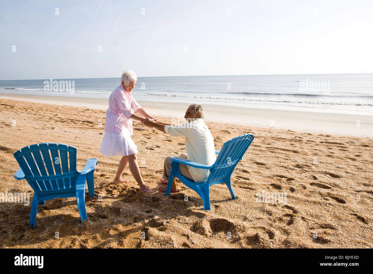 Senior couple having fun spending time at the beach Stock Photo - Alamy