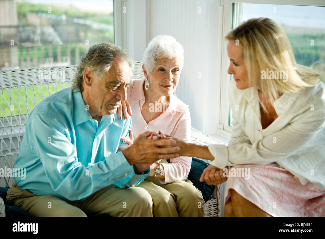 Senior couple having discussion with adult daughter Stock Photo - Alamy