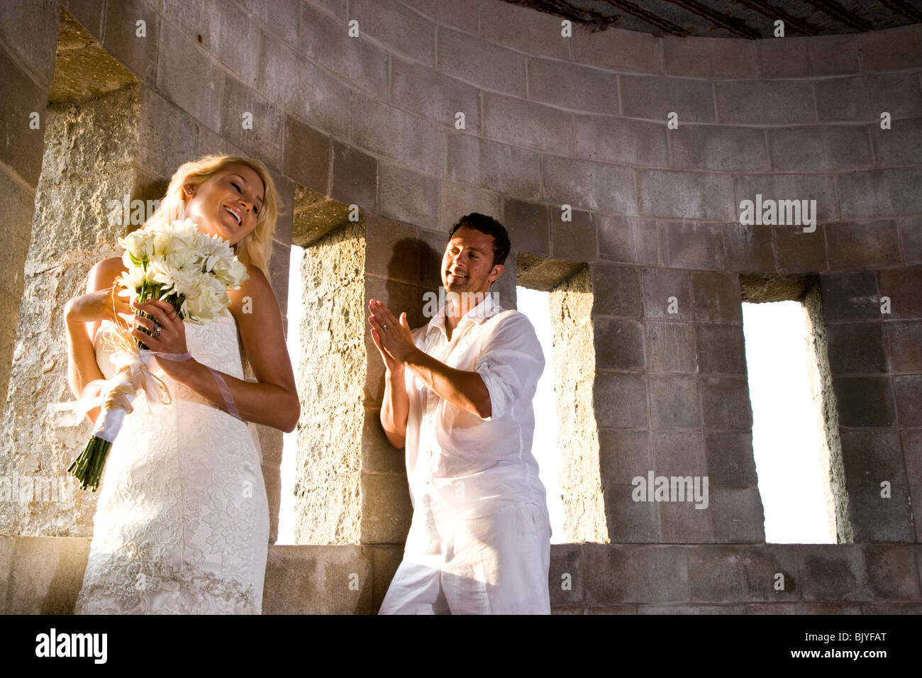 Bridal couple in tower of stone building Stock Photo - Alamy