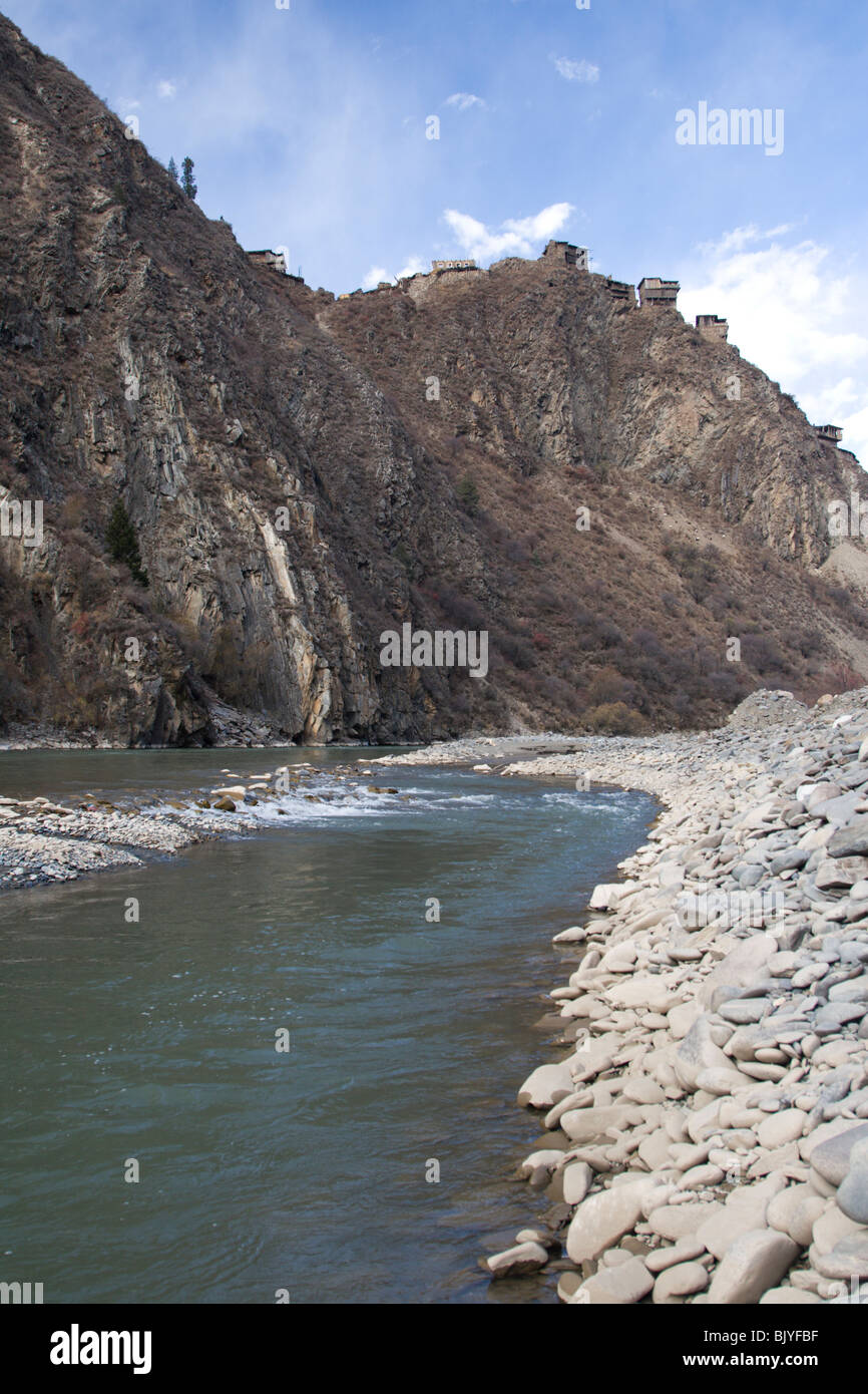 Tibetan houses build on a mountain ridge atop a cliff along the Dadu ...