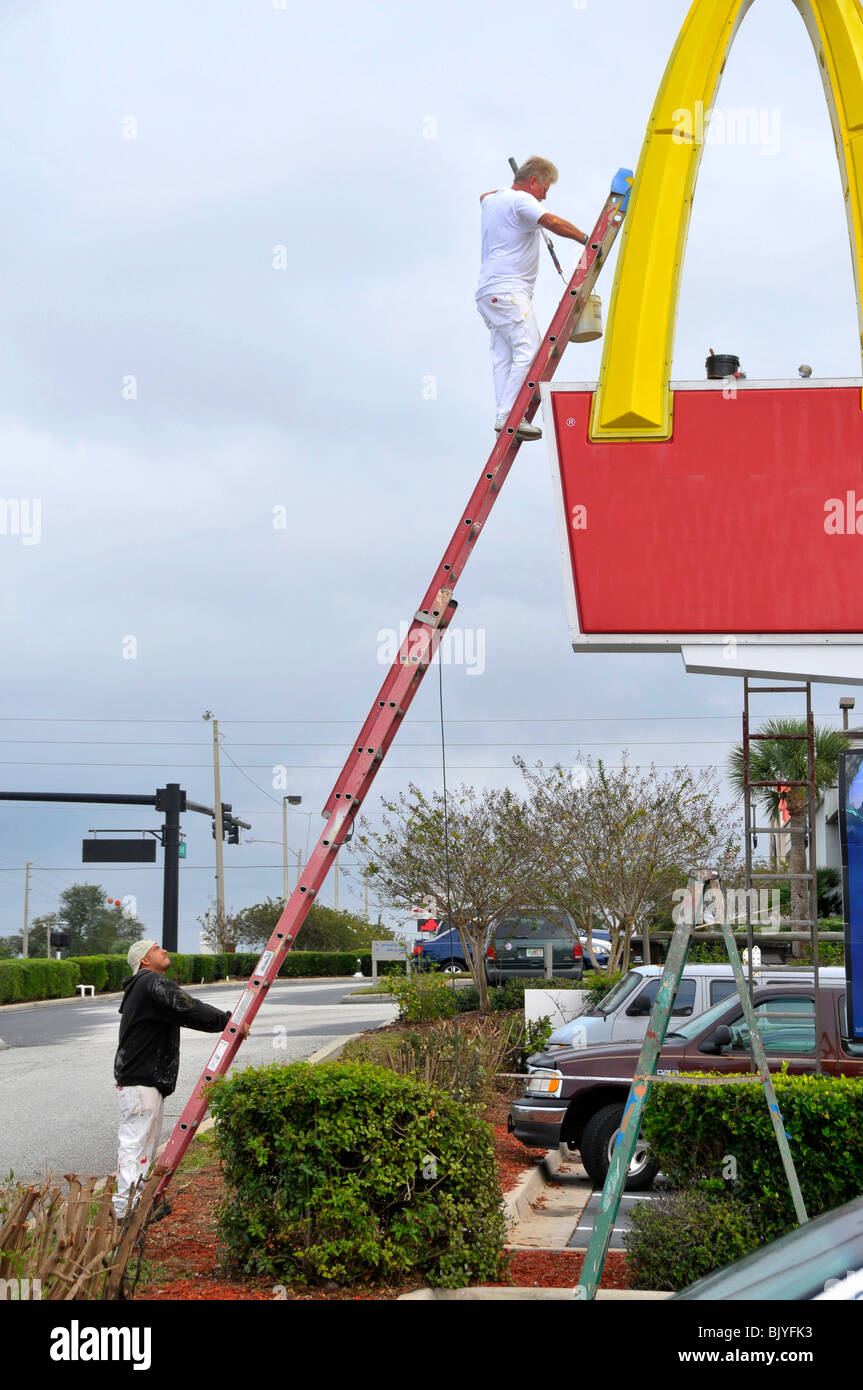 Restoration painting repair on commercial sign Stock Photo - Alamy