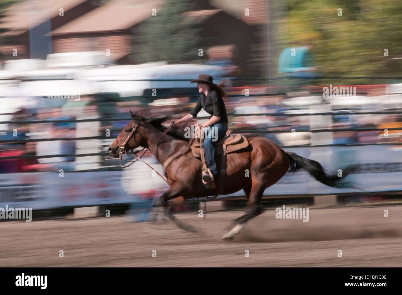 Motion blur of a cowgirl riding fast during barrel racing, Cochrane ...