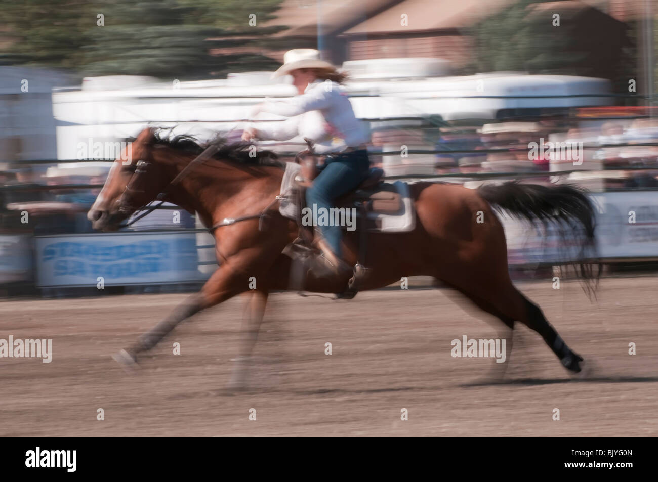 Motion blur of a cowgirl riding fast during barrel racing, Cochrane ...