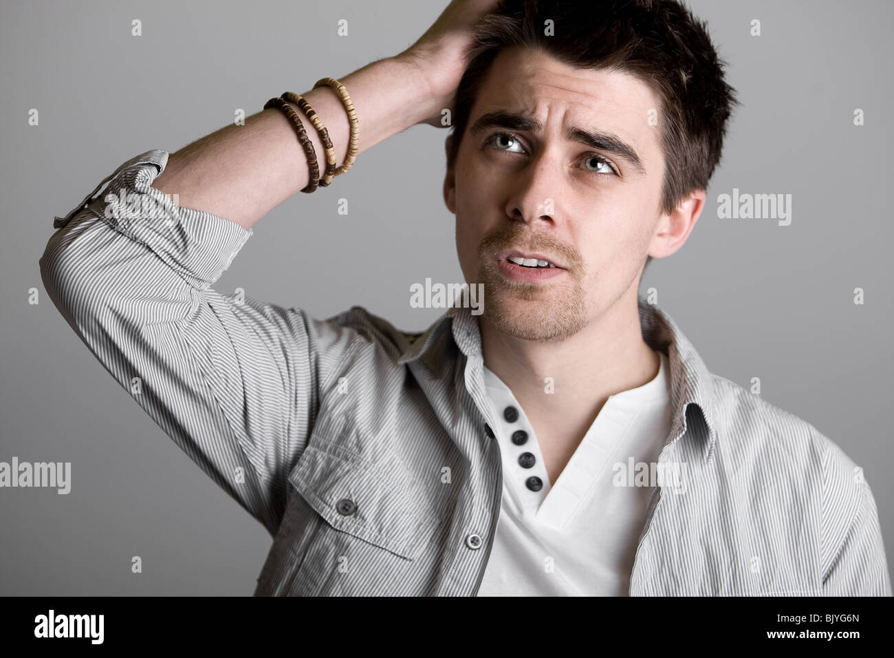Shot of a Handsome Male Scratching his Head Stock Photo - Alamy