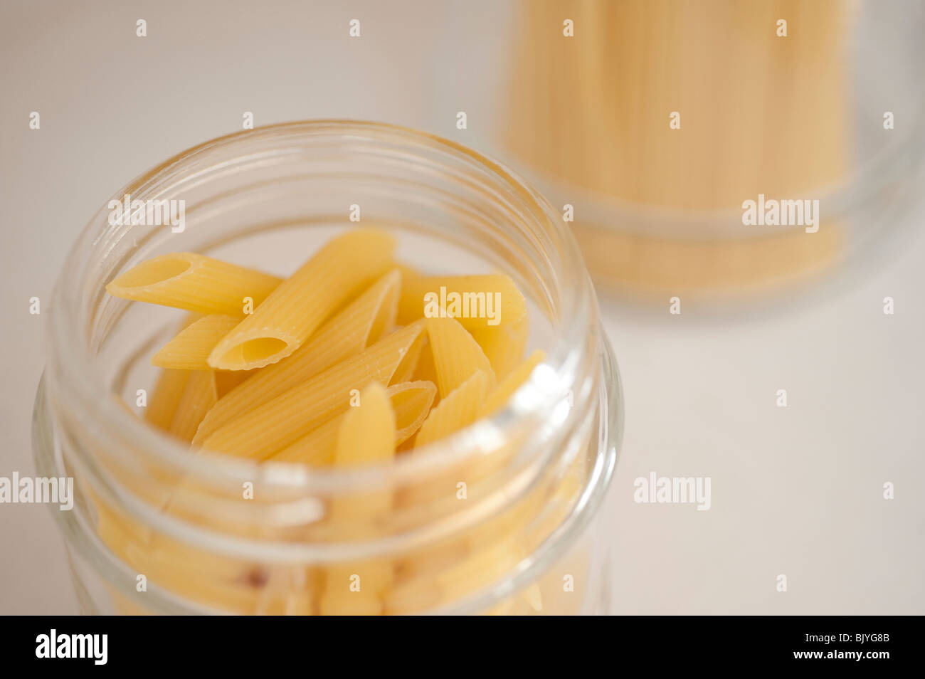 Dried Penne pasta in glass jar Stock Photo - Alamy