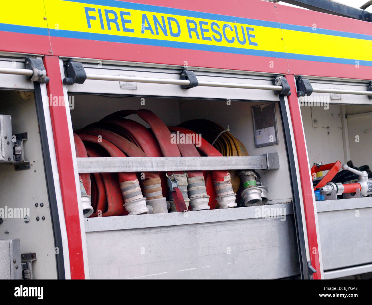 A fire engine on standby with equipment storage open Stock Photo - Alamy
