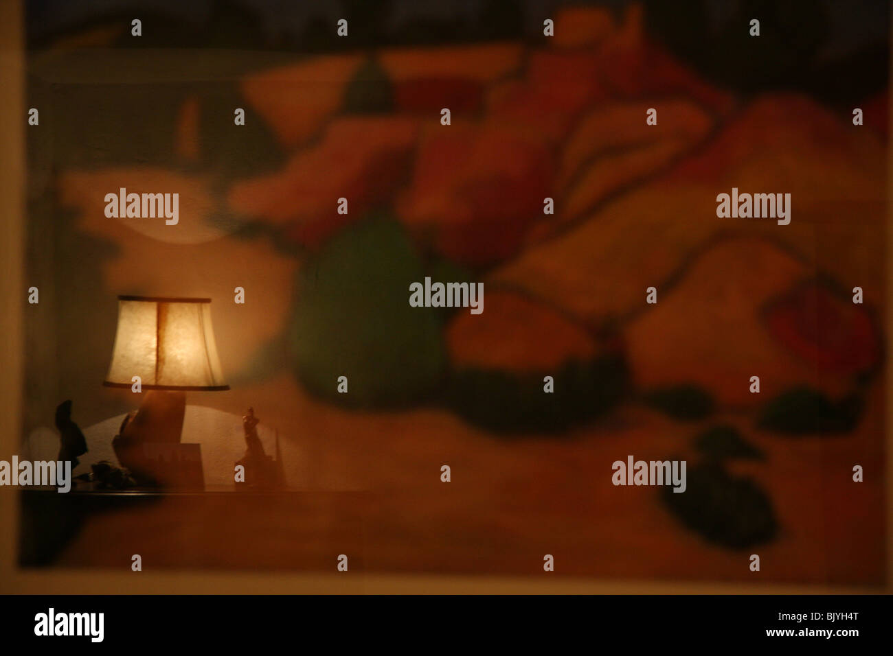 The reflection of a lamp in an oil painting in a French home in ...