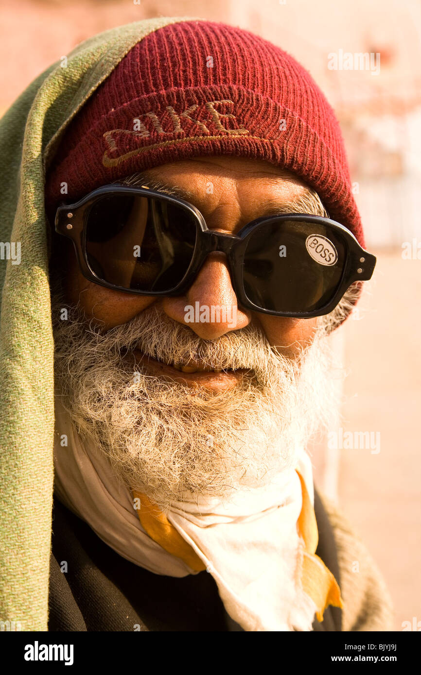 An Indian man wears a woolly hat and sun glasses in Varanasi, India ...